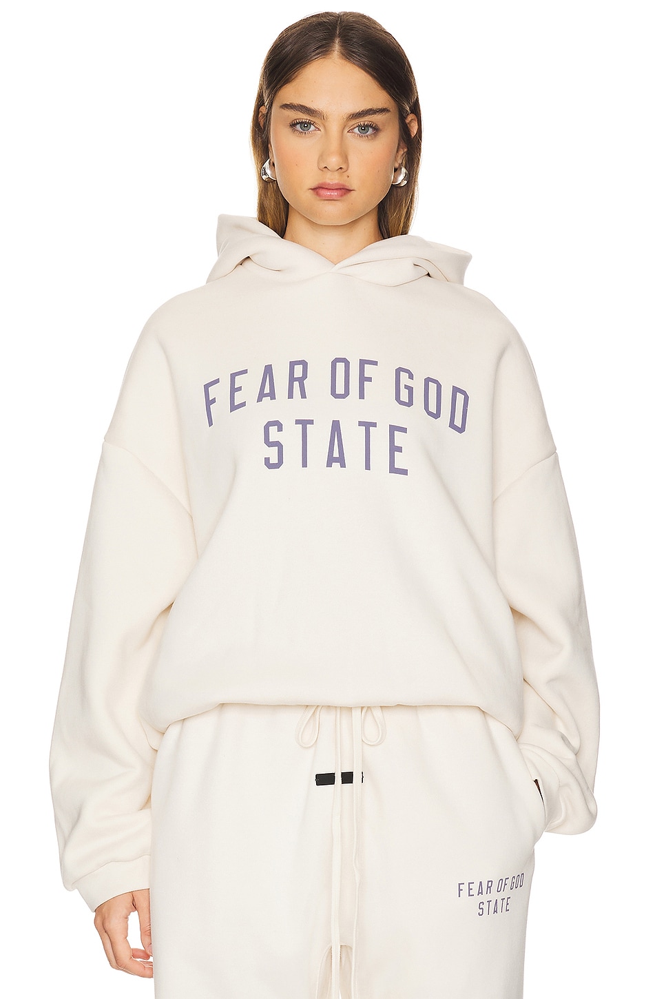 Fear of God ESSENTIALS Fleece Hoodie in Shell | REVOLVE