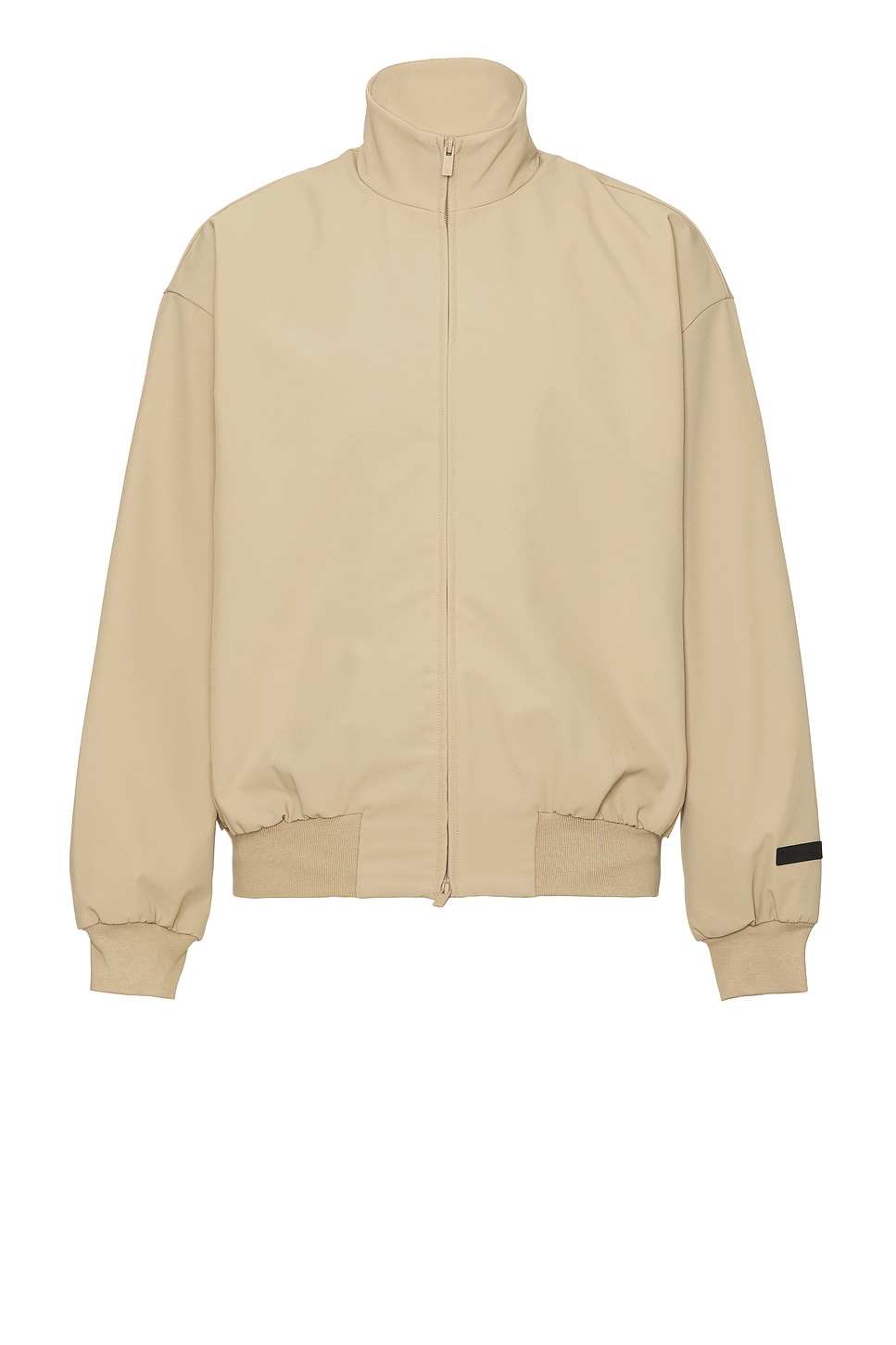 Fear of God ESSENTIALS Bonded Nylon Bomber Jacket in Desert Sand | REVOLVE